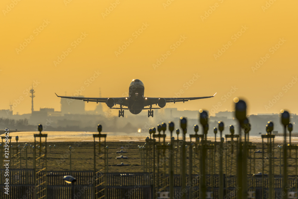 Front view of a plane taking-off in front of city skyline Stock Photo ...