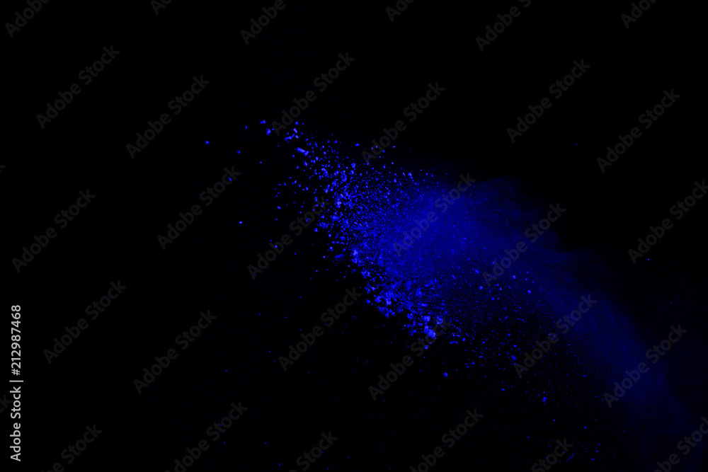 Abstract blue dust explosion on black background. abstract blue powder ...