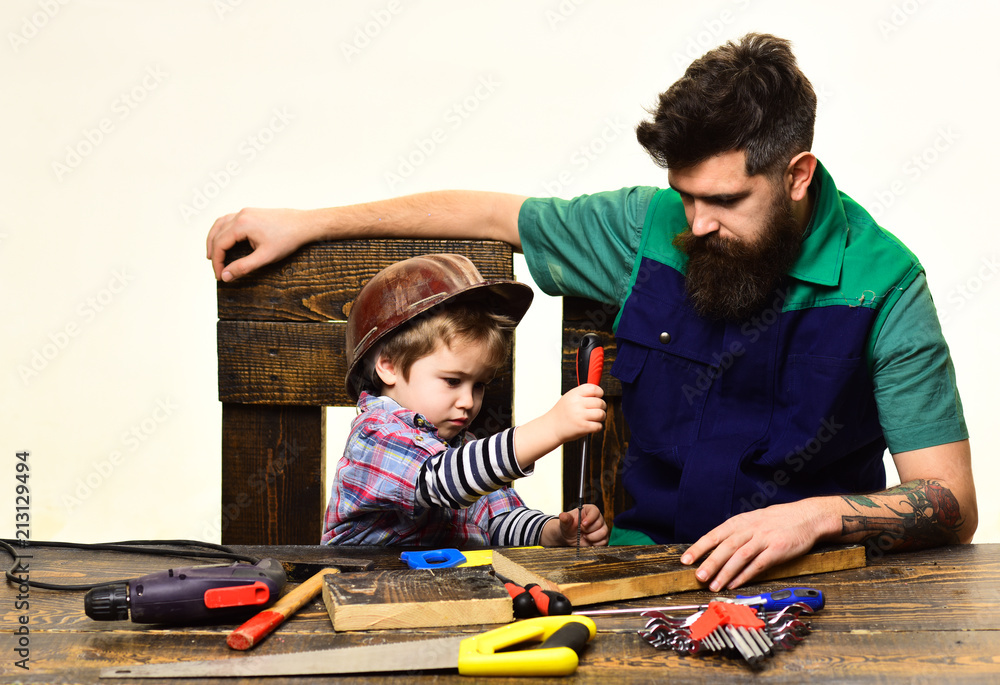 Father teaching little son to repair. Dad&son working with tools ...