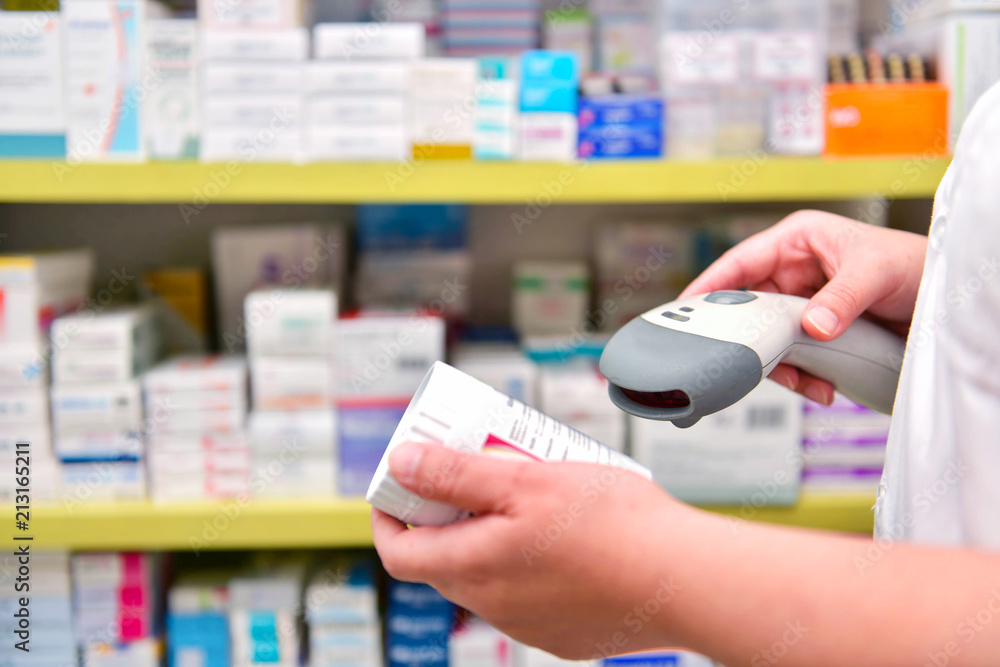 Pharmacist scanning barcode of medicine drug in a pharmacy drugstore ...
