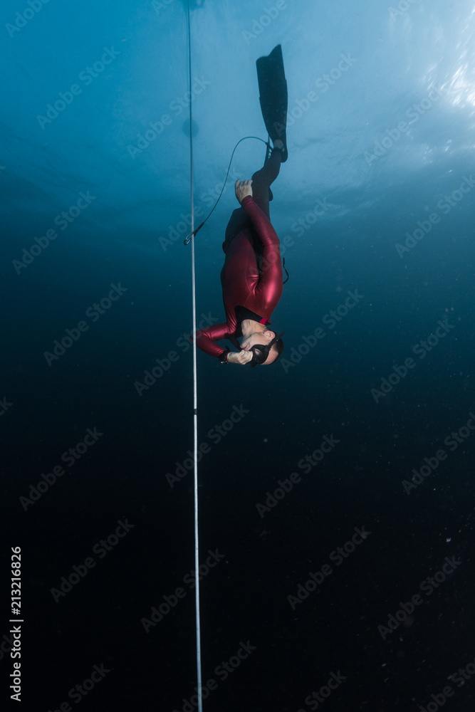 Freediver glides along the rope during the free fall phase of dive ...