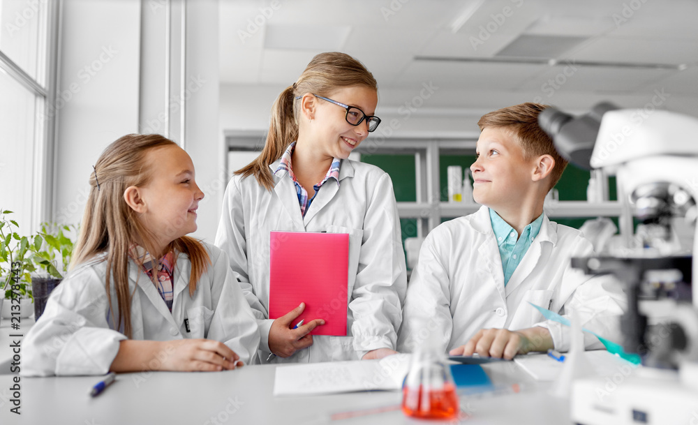 education, science and children concept - happy kids with workbooks ...