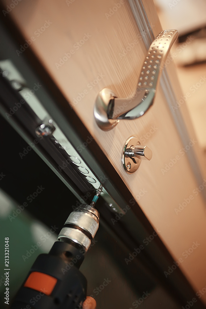 installation of a lock in the door Stock Photo | Adobe Stock