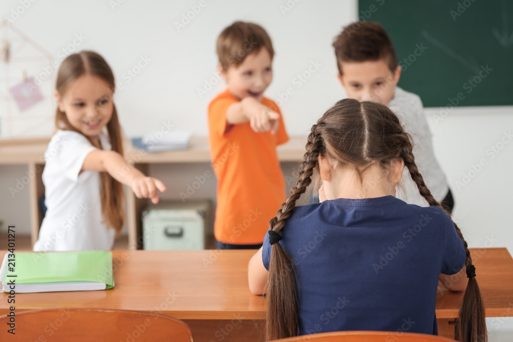 Children bullying their classmate in school Stock Photo | Adobe Stock