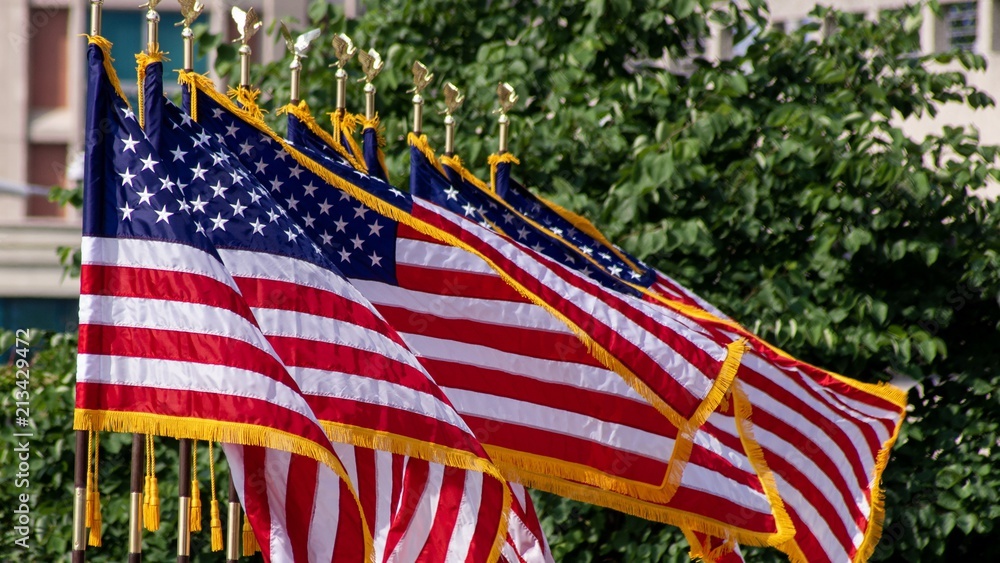 Row of Red white and blue American flags with golden fringe tassels ...