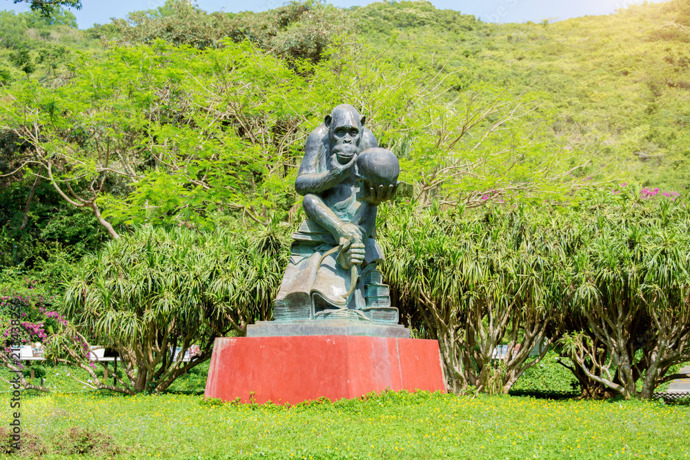 Monkey statue made of stone, in the pose of sensible over the human ...