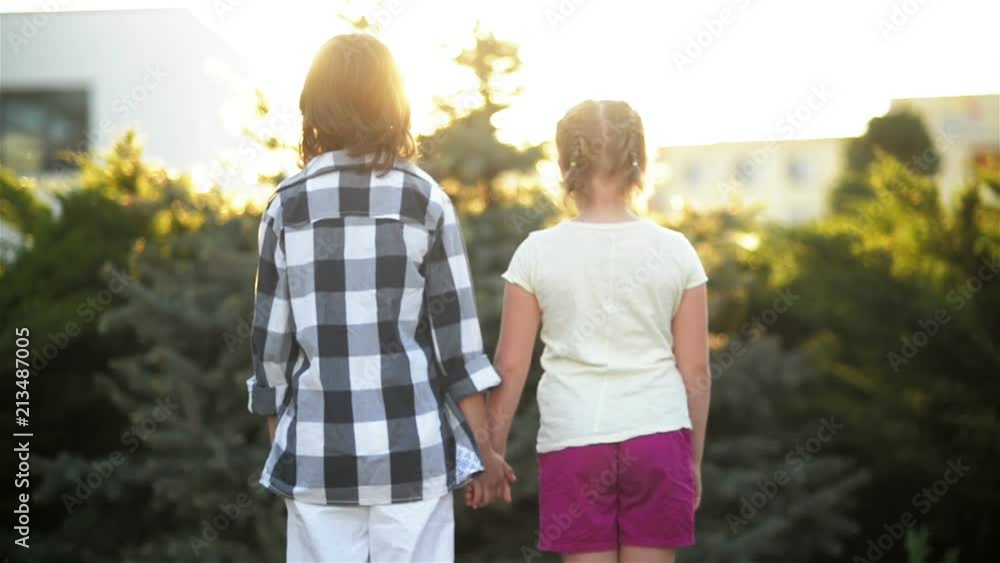 Two Children Stand Back And Hold Hands. Portrait of the Children's Back ...
