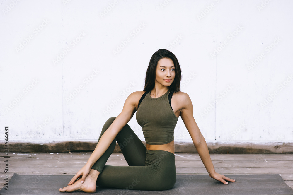 Attractive model in yoga pose on white background in sexual clothes ...