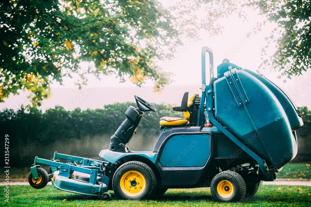 Lawn Mower Tractor On Green Grass. Garden Special Technique Stock Photo ...