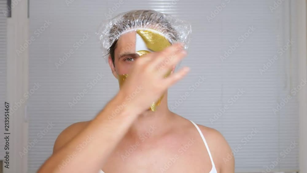 Strange man with face pack. A young man does cosmetic procedures for ...