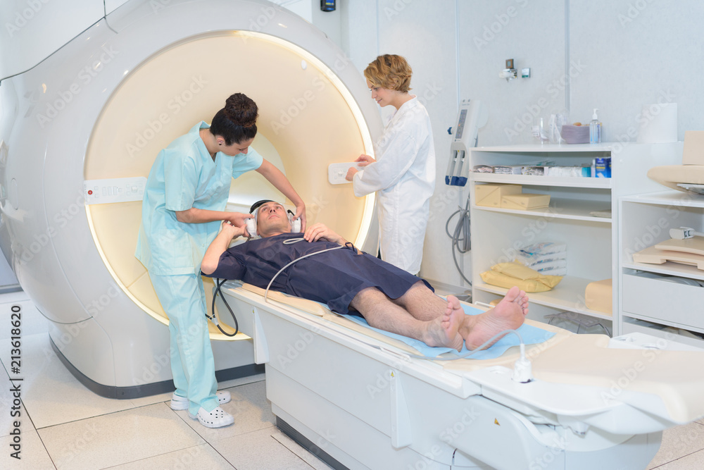 Nurse putting ear protectors on patient for mri scan Stock Photo ...