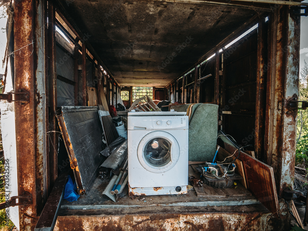 Pile of garbage in old rusty abandoned trailer inside with broken ...