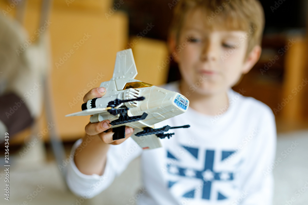 Happy little kid boy playing with space shuttle toy. Stock Photo ...