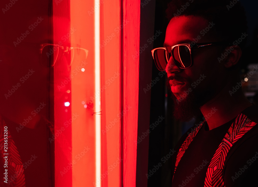 Red lights shining on man Stock Photo | Adobe Stock