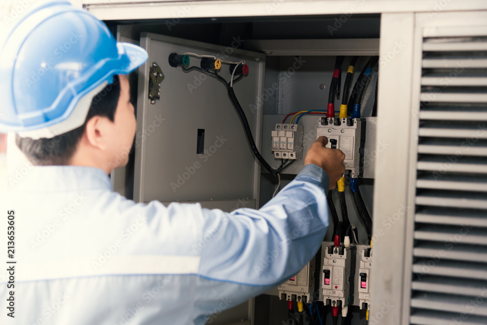 Control Room Engineer. Power Plant Control Panel. Engineer standing in ...