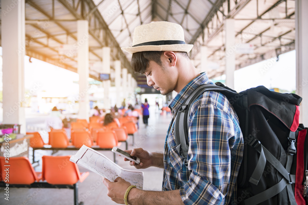 backpack young man traveler search destinations by map at the bus ...
