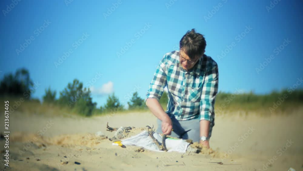 The man is engaged in excavating bones in the sand, Skeleton and ...