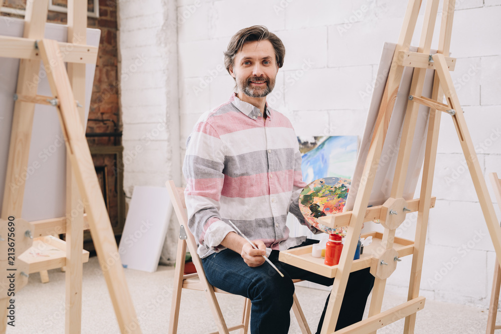 Person Painting On Easel