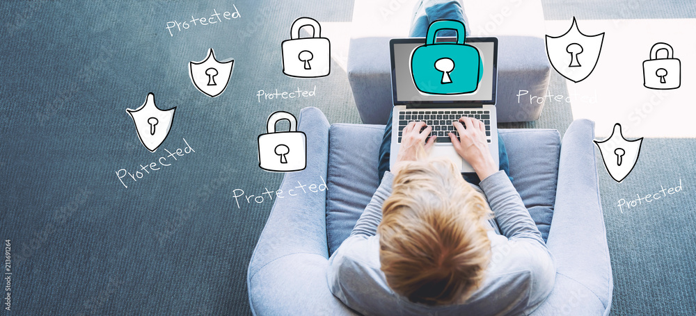 Cyber Security with man using a laptop in a modern gray chair Stock ...