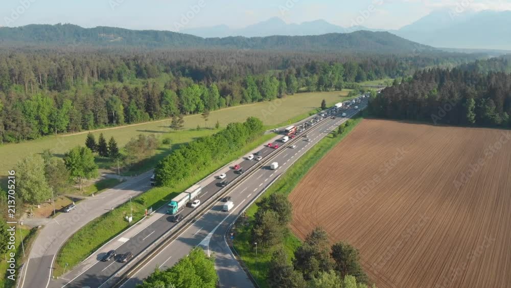 AERIAL: Flying above dense highway traffic slowly forming into a ...