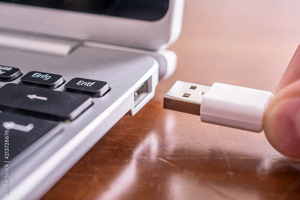 Male Hand Connecting A White USB Cable To The USB Port Of A Small ...
