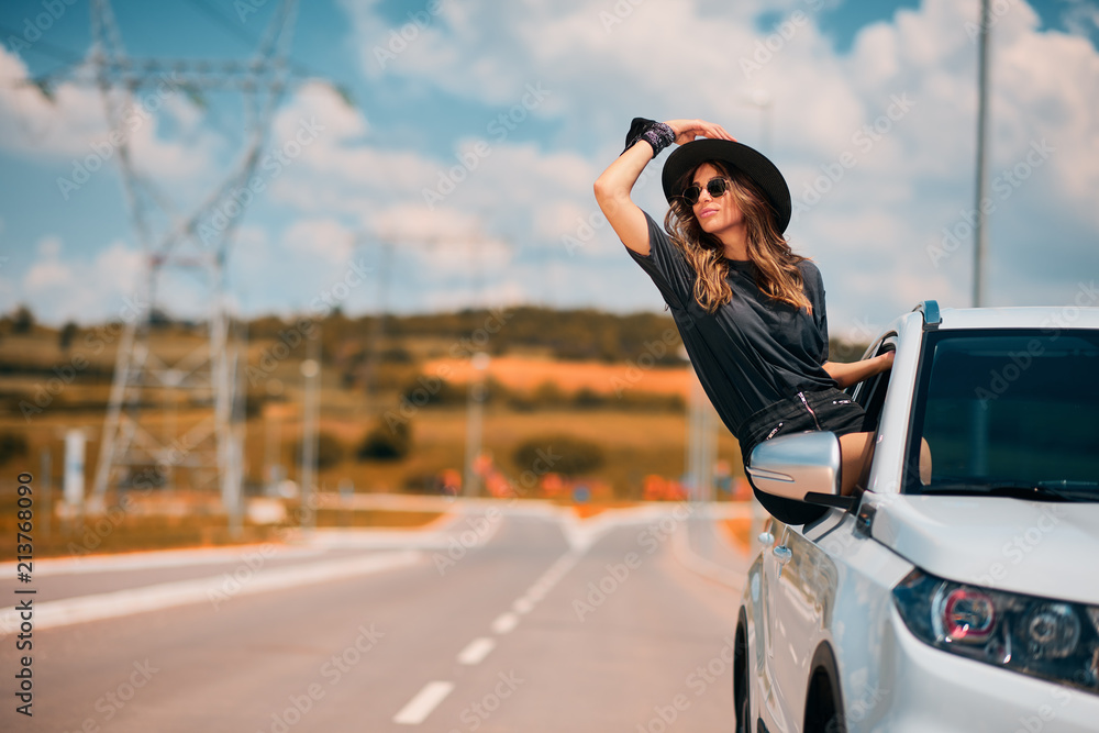 woman posing on car window Stock-Foto | Adobe Stock