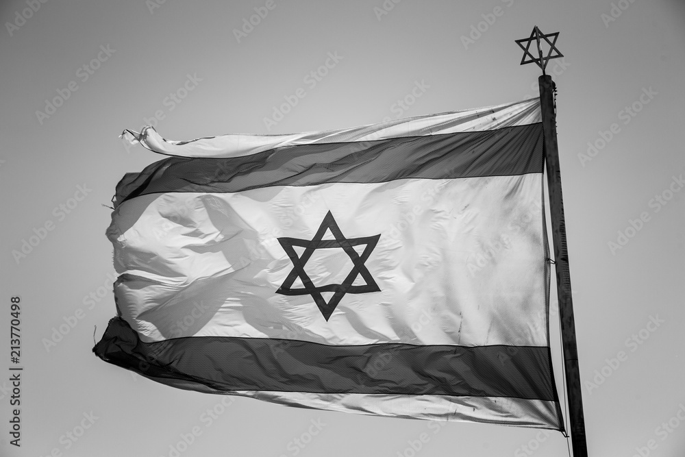 Israeli Flag in the wind with blue sky background with an iron star of ...