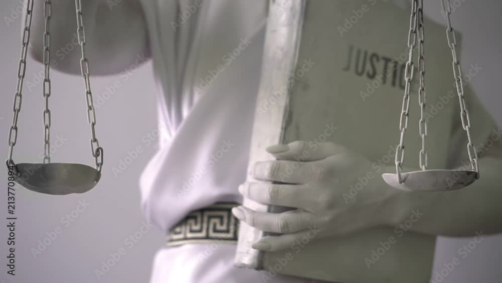 woman in a stone statue costume. Femida the goddess of justice on a ...