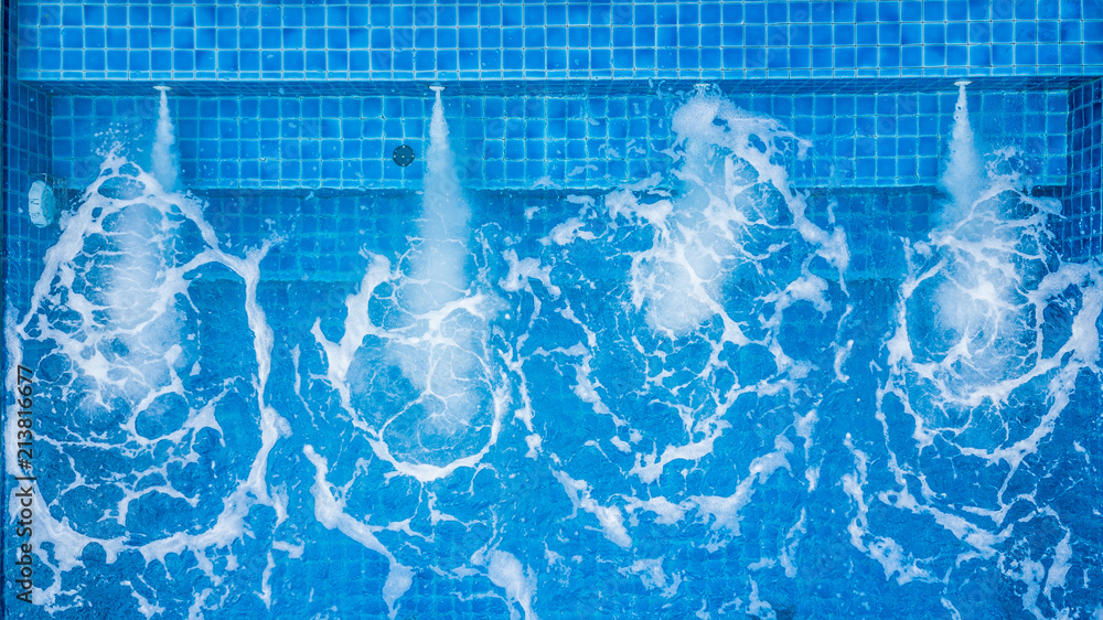 Aerial top view water ripples on blue tiled swimming pool background ...