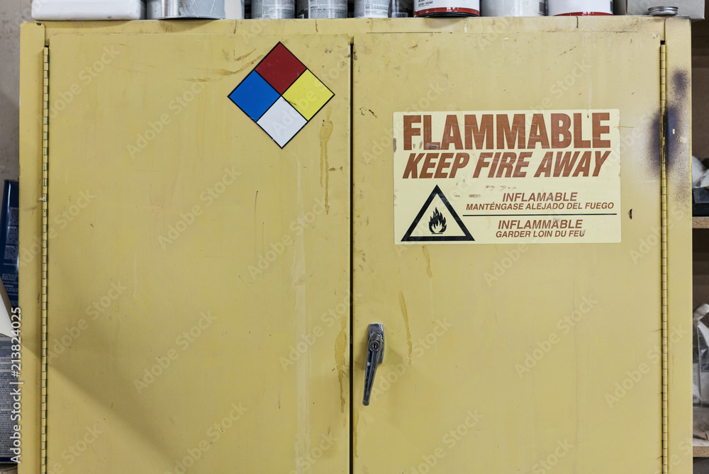 Safety sign reminders mounted to a metal cabinet in a woodworking ...