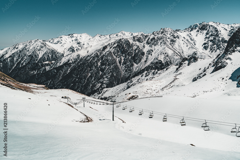 Ski lift in Almaty mountains. Shymbulak Ski Resort Hotel now-capped ...