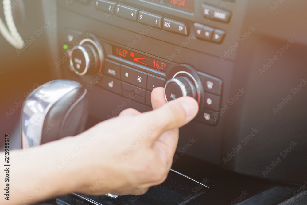 Man adjusting the car air conditioner. Closeup of temperature ...