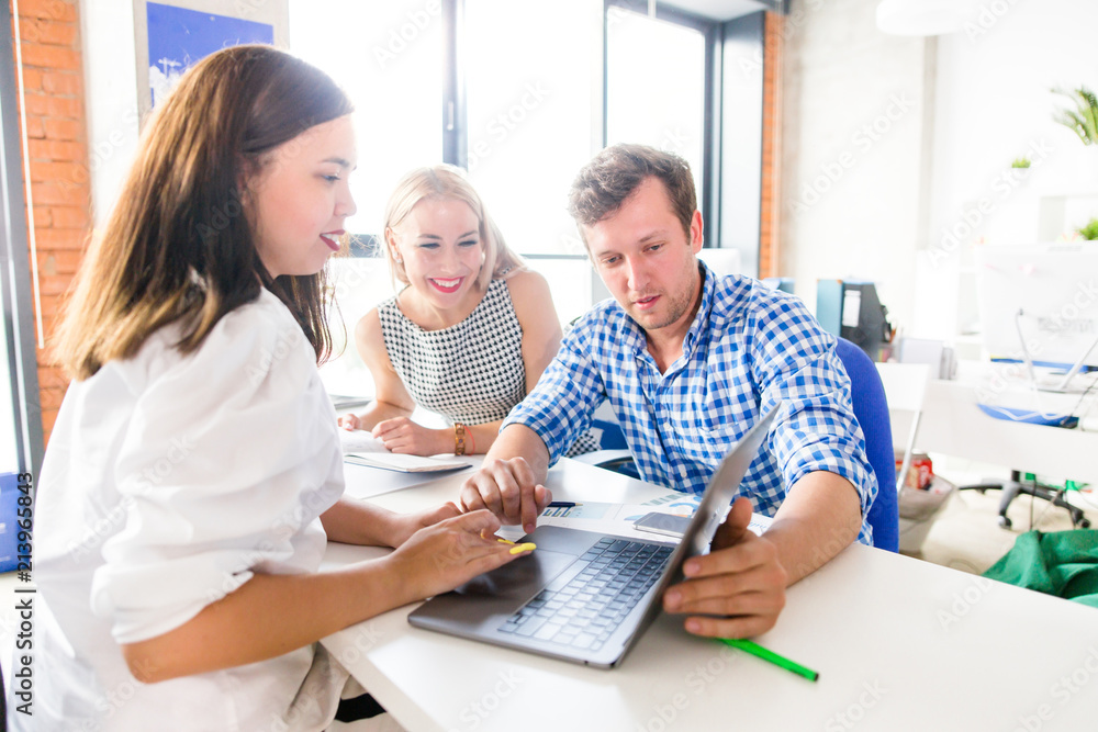 Project team working together at a Desk in a laptop on a conference ...