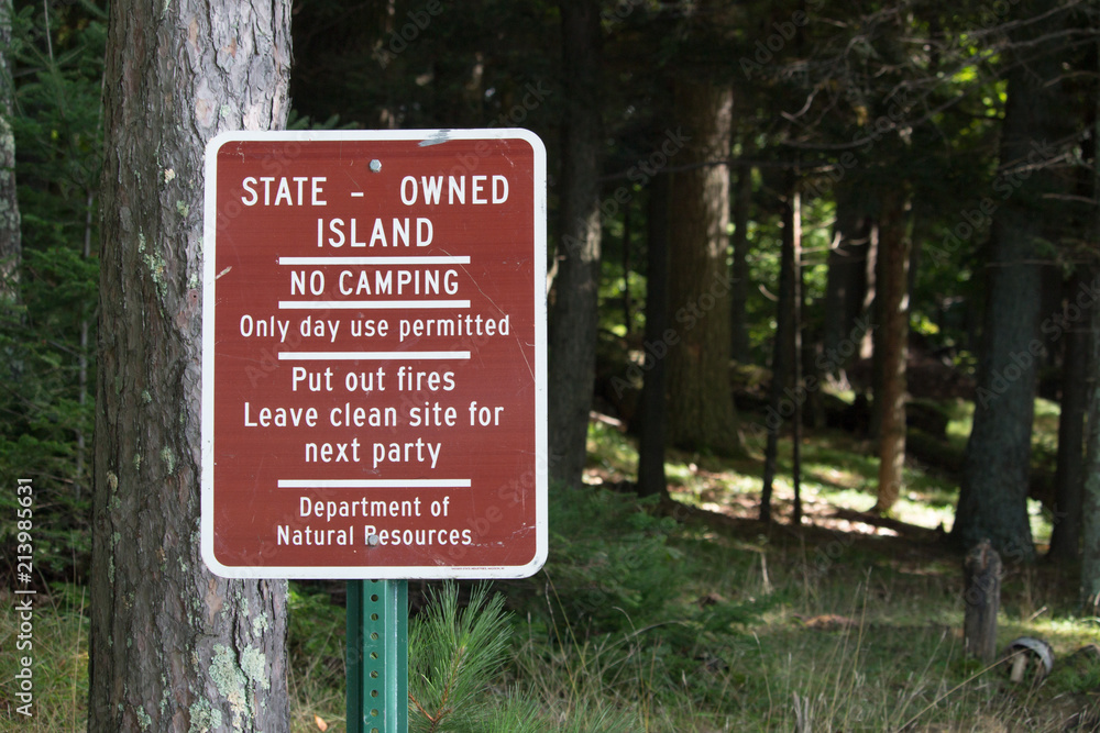 Colorful red sign says State-Owned Island, no camping, day use only ...