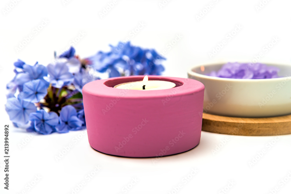 Beautiful spa composition . Blue flowers and candlelight on a white ...
