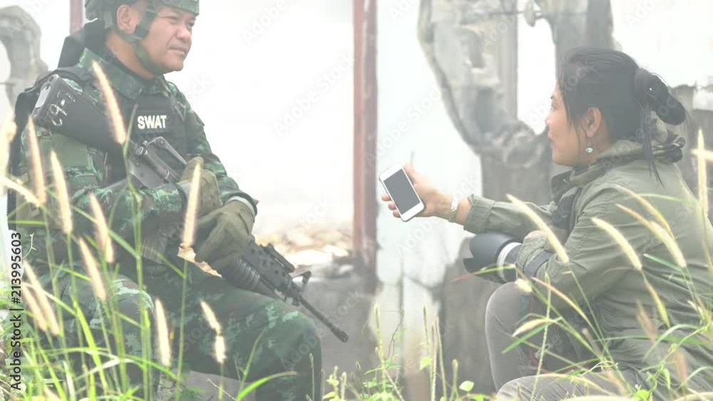 Soldier fieldwork interview with presswoman. Reporter unsafe area ...