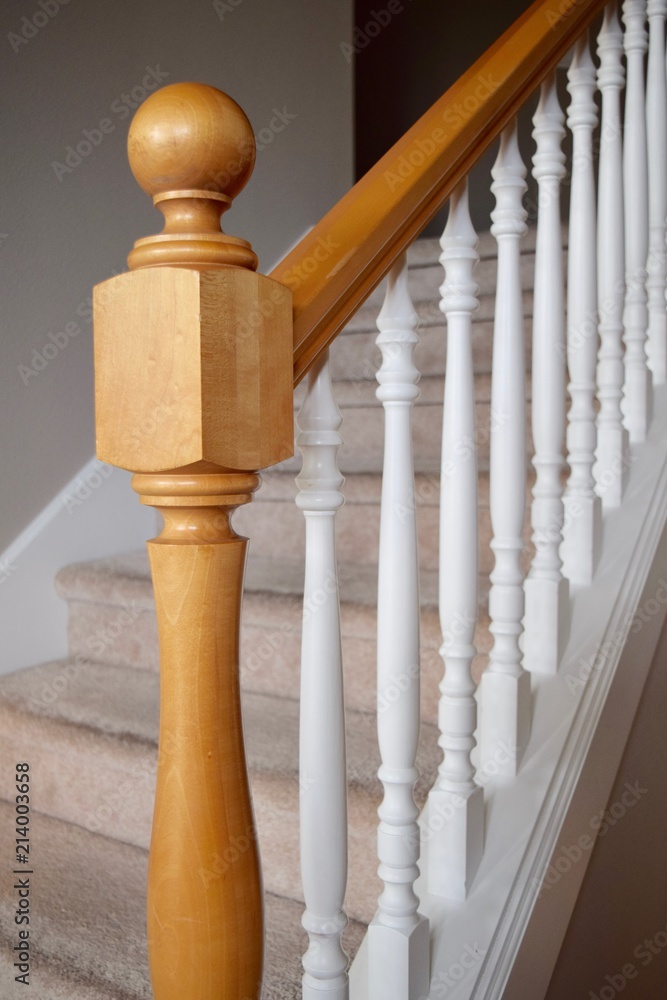 Newel post and white spindles on interior home staircase foto de Stock ...