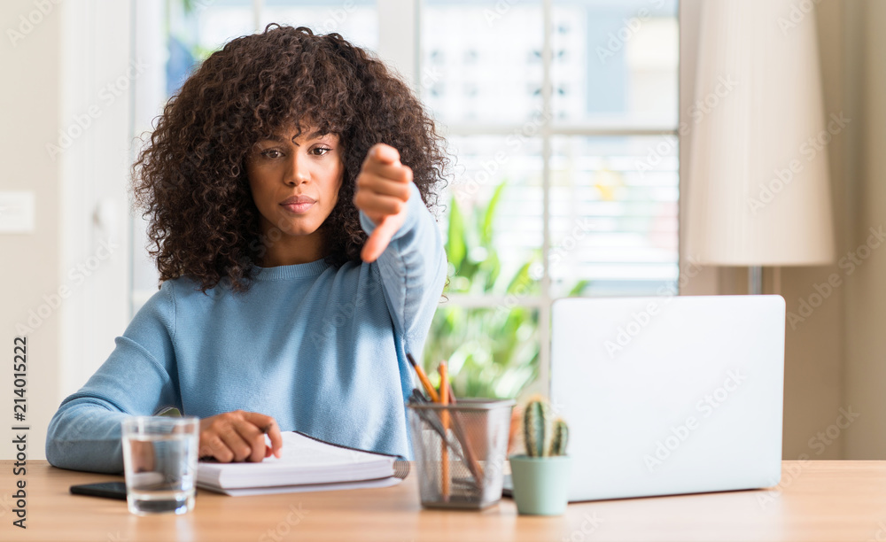 African american woman studying at home using a computer laptop with ...