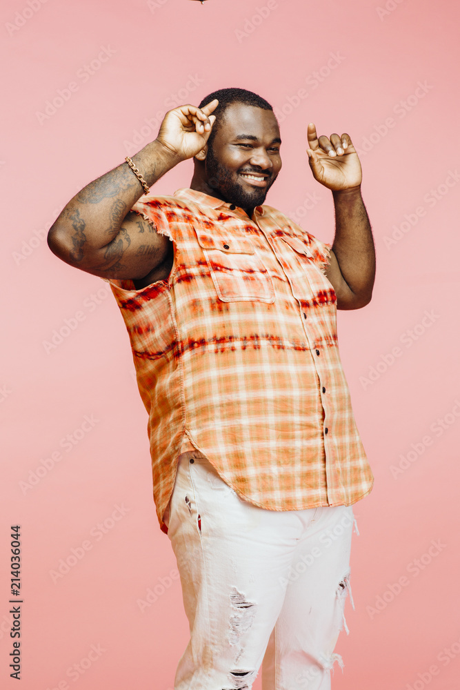 Happy plus size man dancing with arms up, feeling great Stock Photo ...