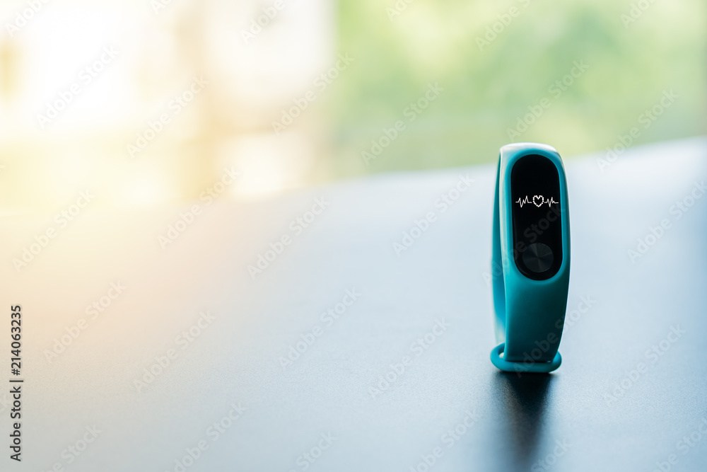 fitness smart band device blue color on black background with heart ...