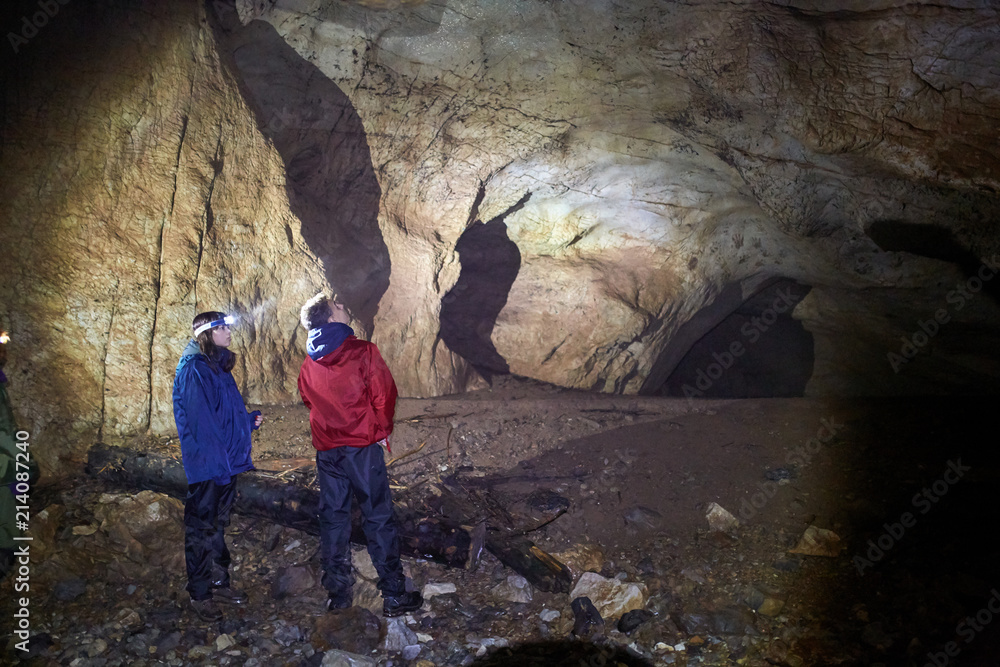 Poster Hikers family exploring a cave – Wall Art | UkPosters