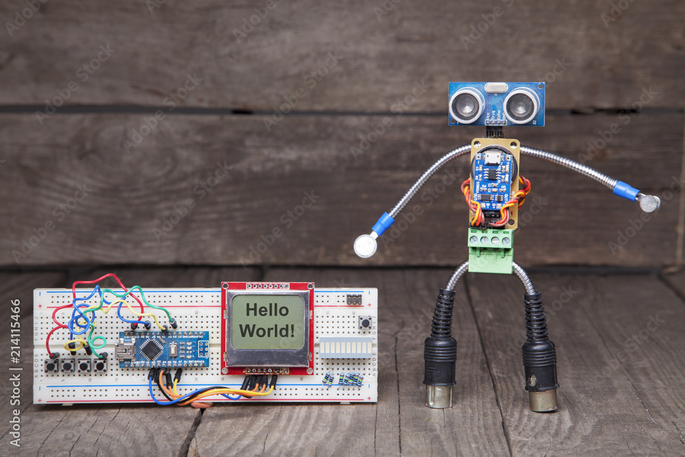 Robot made of parts of circuit boards with wrench near the debug board ...