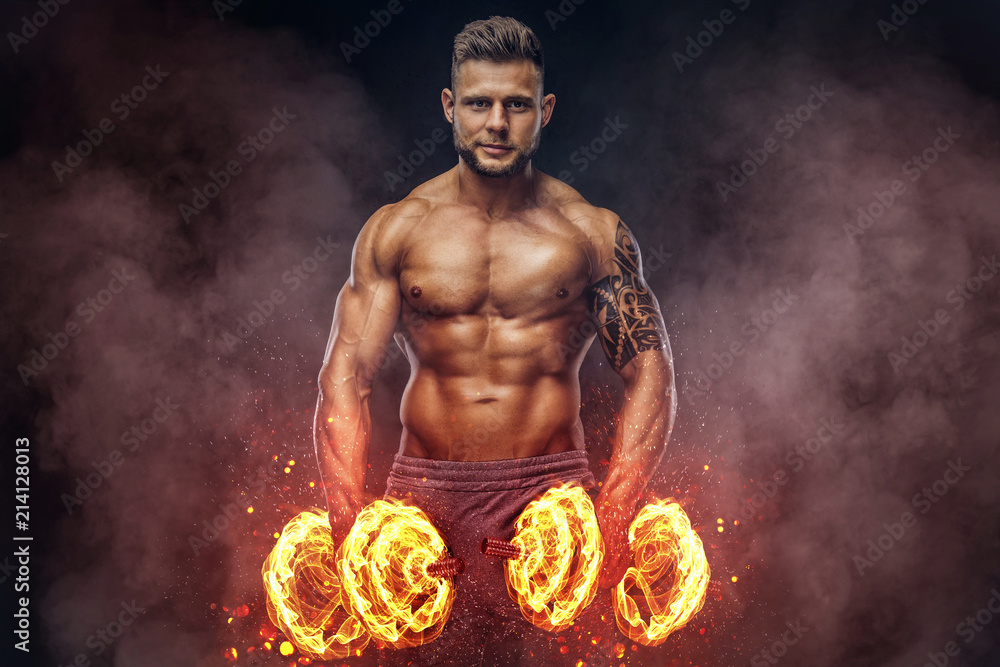 Handsome shirtless tattooed bodybuilder with stylish haircut and beard ...