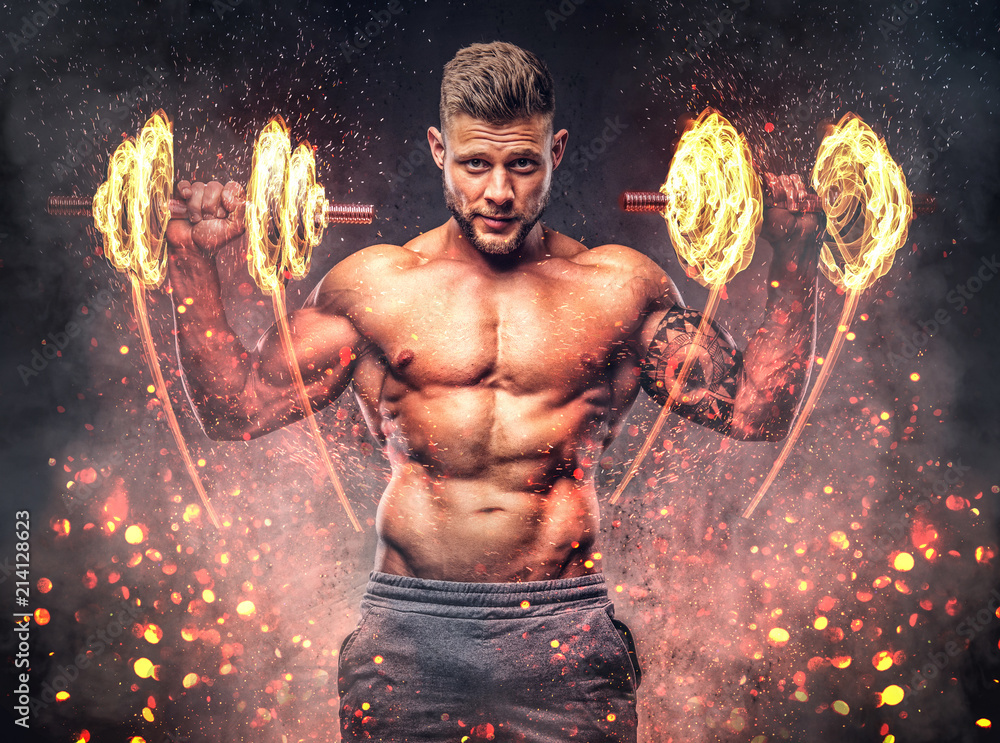 Handsome shirtless tattooed bodybuilder with stylish haircut and beard ...