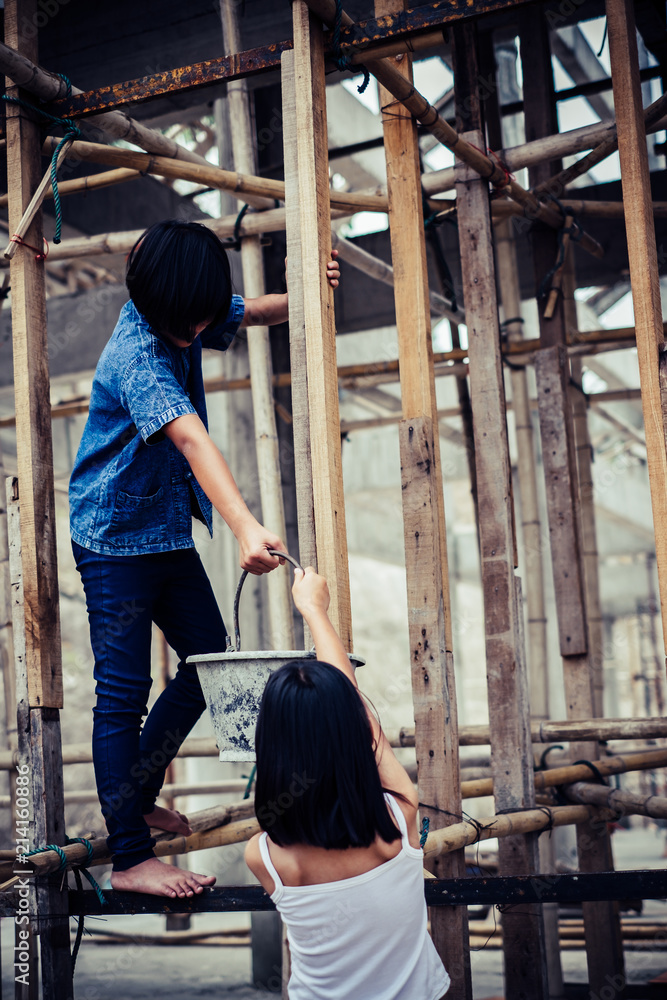 Little girl labor working in commercial building structure, World Day ...
