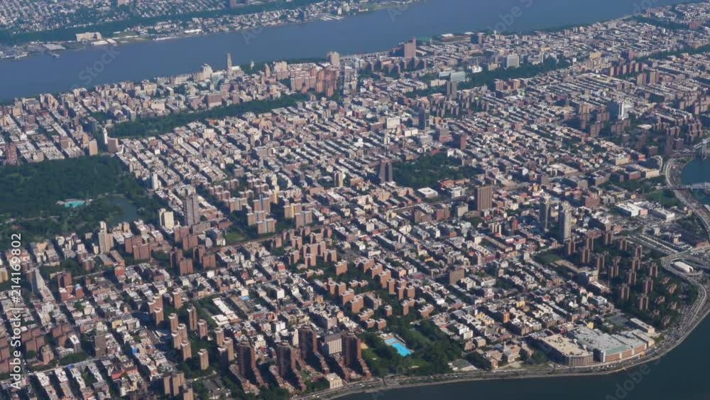 An aerial flyover view of the northern end of Manhattan on a summer day ...
