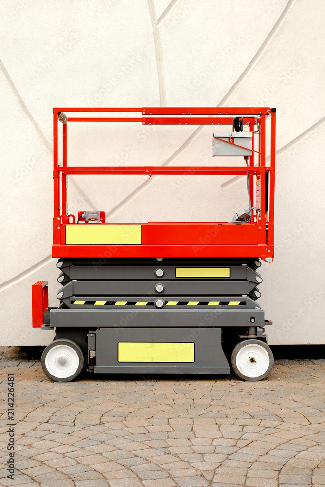 Hydraulic scissor work lift in front of modern facade. Stock Photo ...