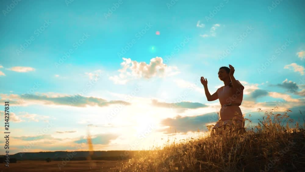 Girl folded her hands in prayer silhouette at sunset. woman praying on ...