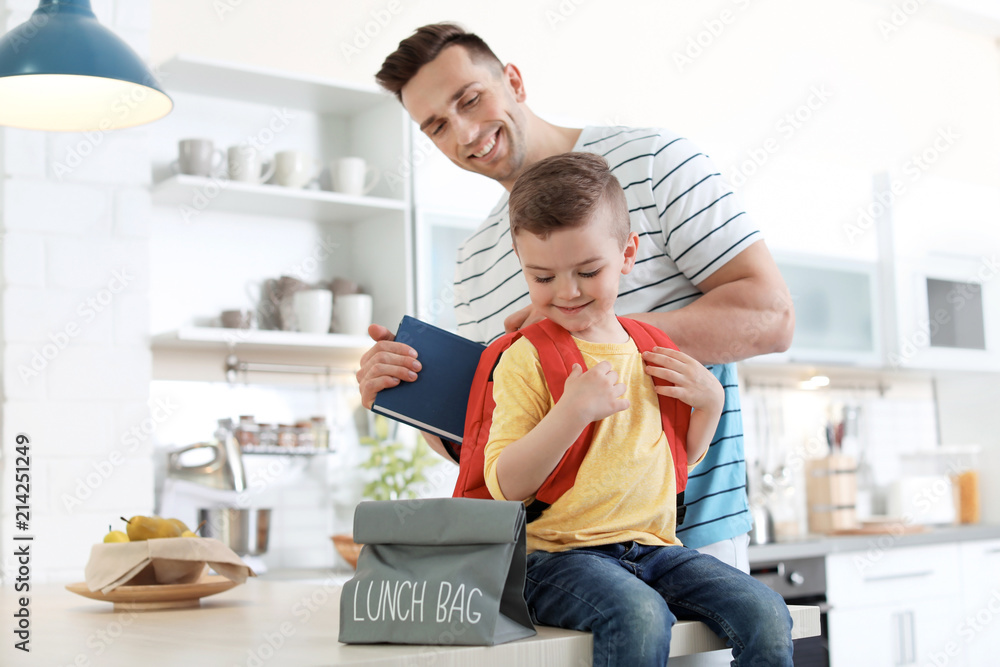 Young man helping his little child get ready for school at home Stock ...