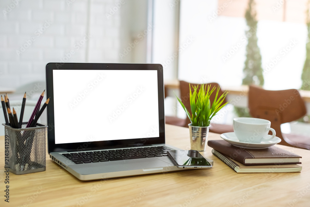 Mockup white screen laptop on table. workspace with blank screen laptop ...
